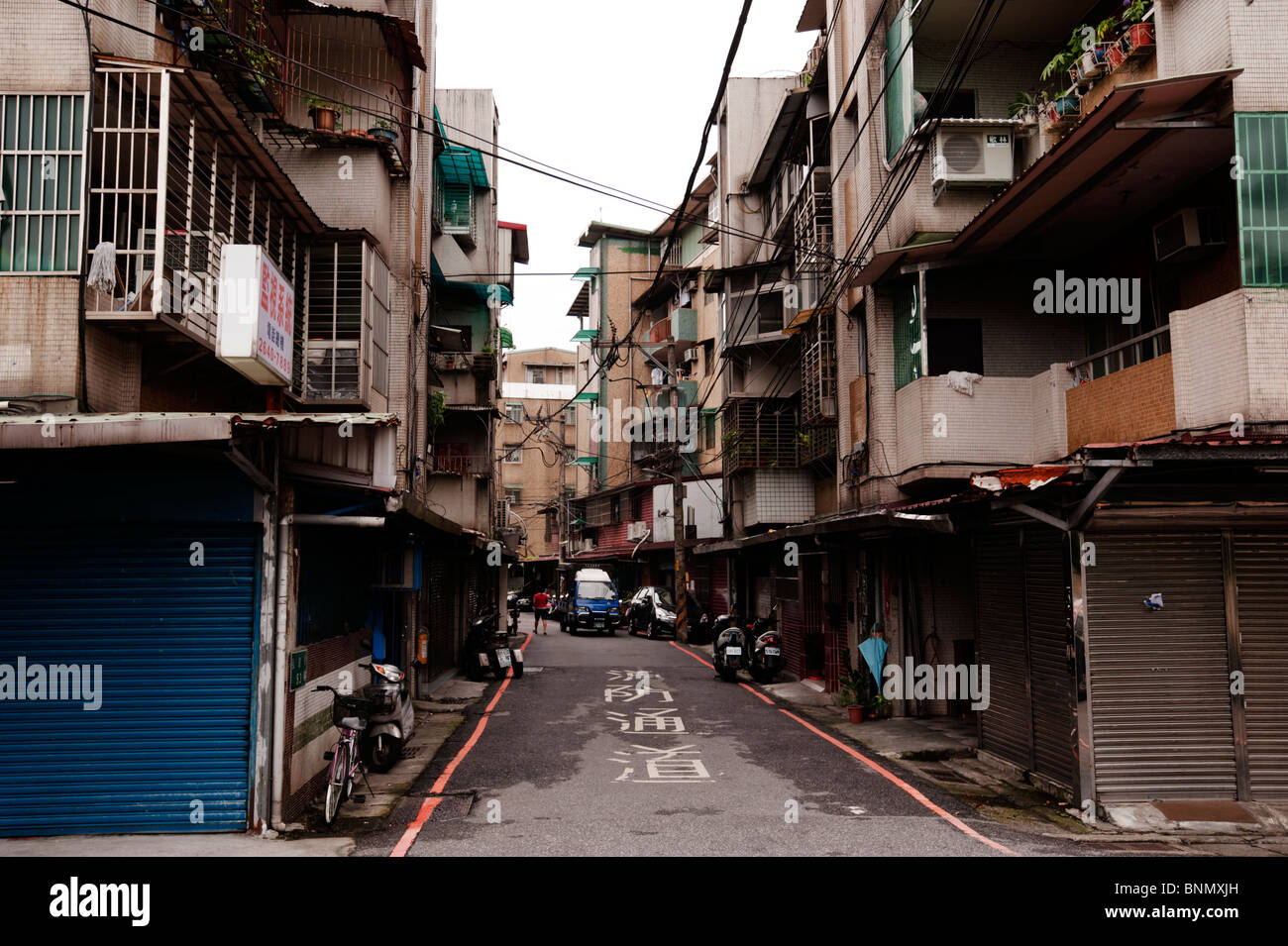 A typical street runs between low-rise apartment houses in Taipei Stock ...