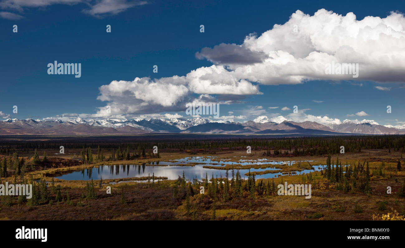 Scenic view of a kettle pond with the Alaska Range in the background ...