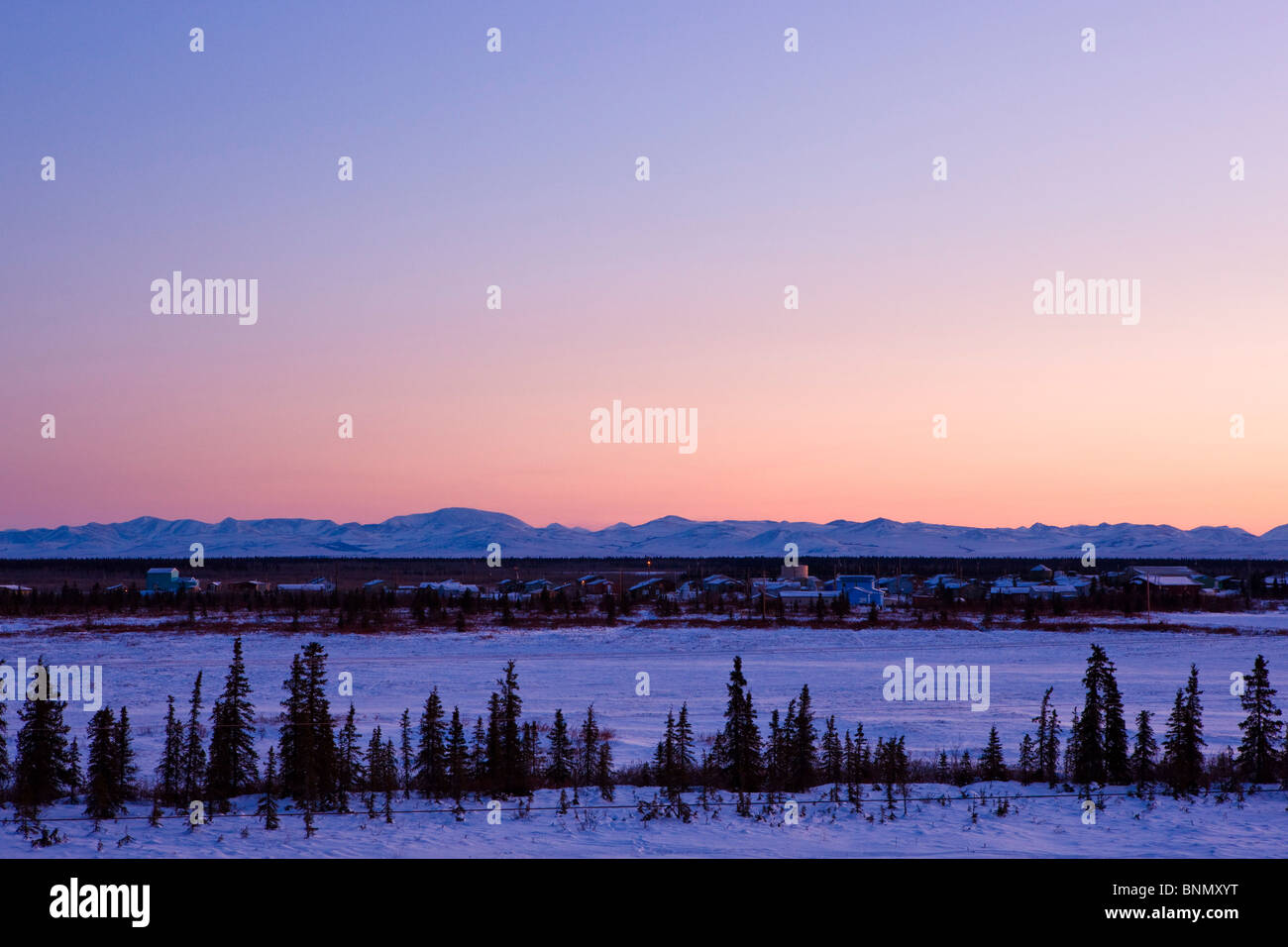 Sunset over a barren landscape near the Village of Noatak with the ...