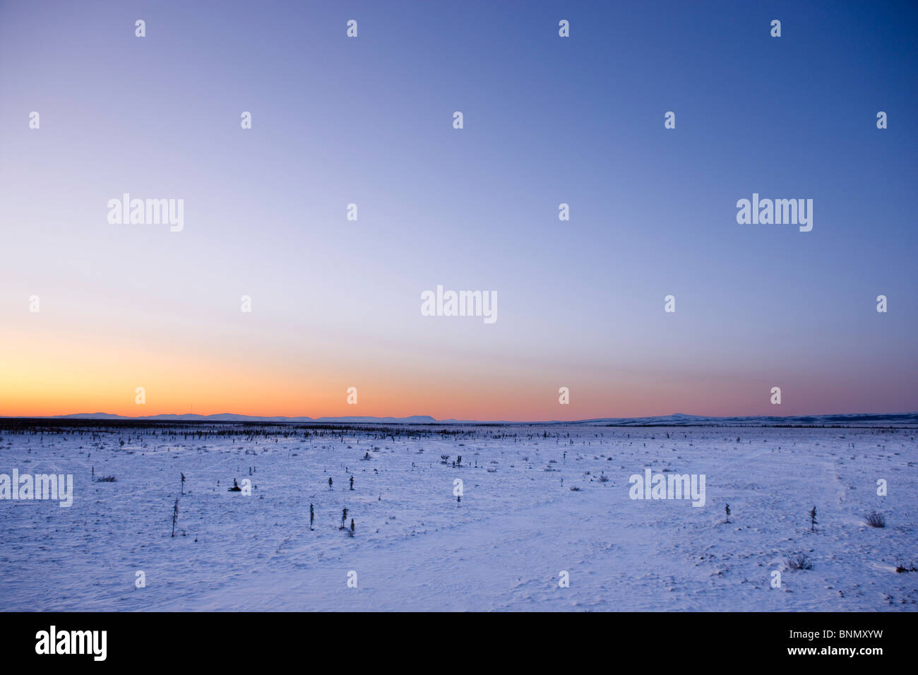 Sunset over a barren landscape near the Village of Noatak with the ...