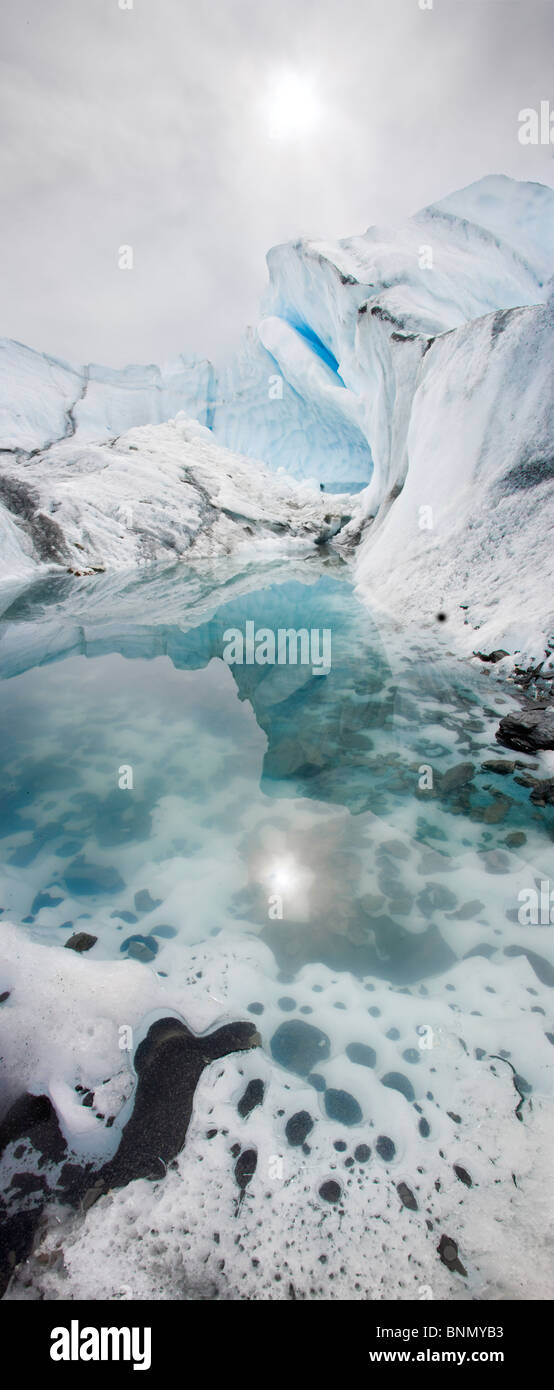 Sun reflected in a pool of glacier water with ice fins on the Matanuska ...