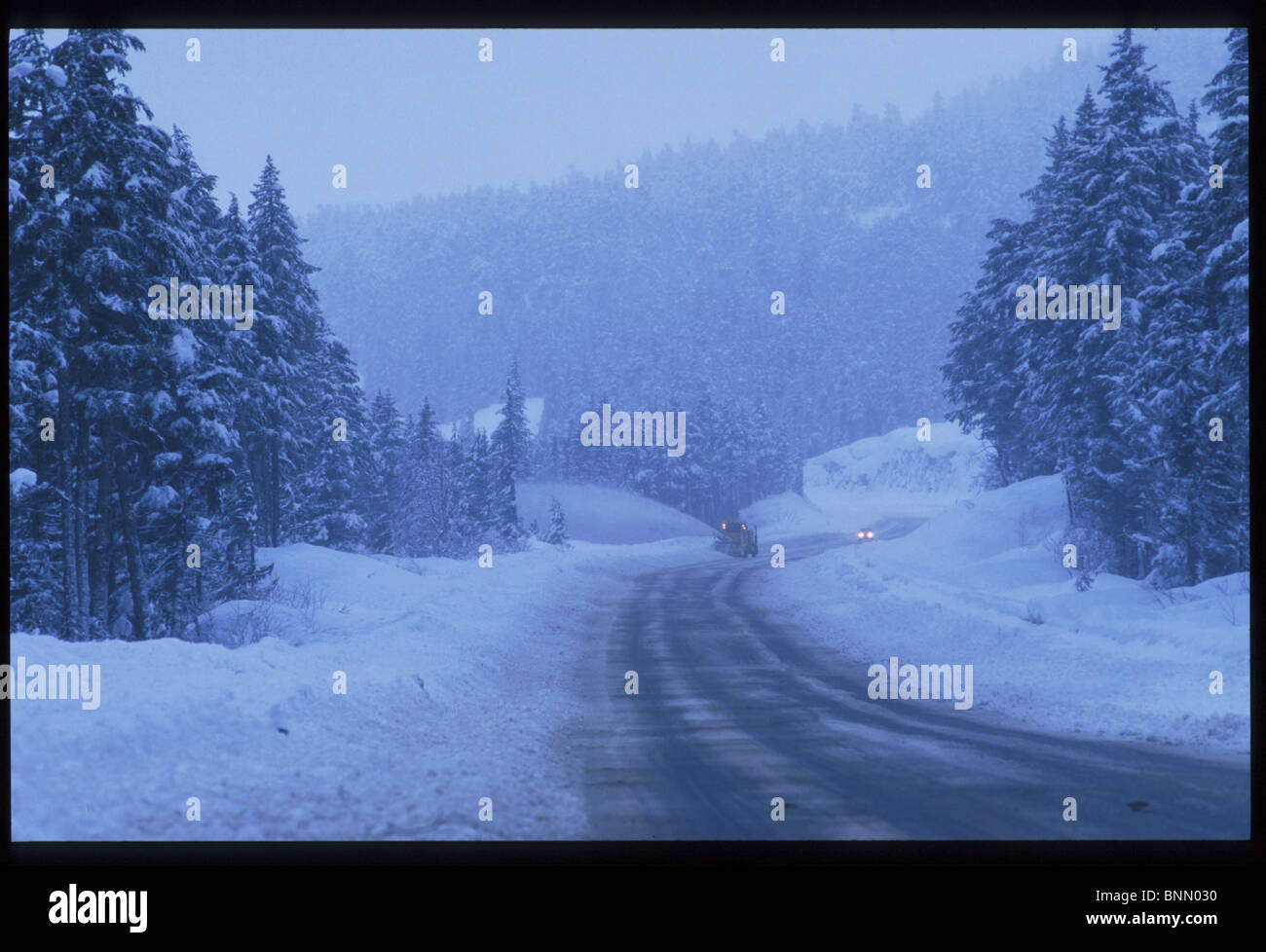 Vehicles driving Turnagain Pass Seward Hwy SC AK winter scenic Stock ...