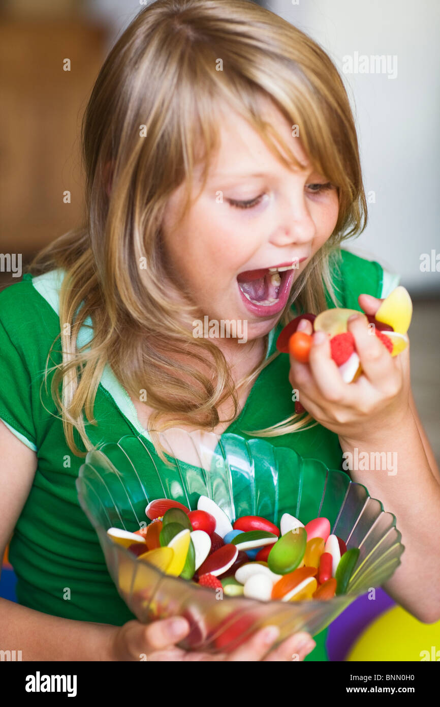Girl eating sweet soft candies Stock Photo - Alamy