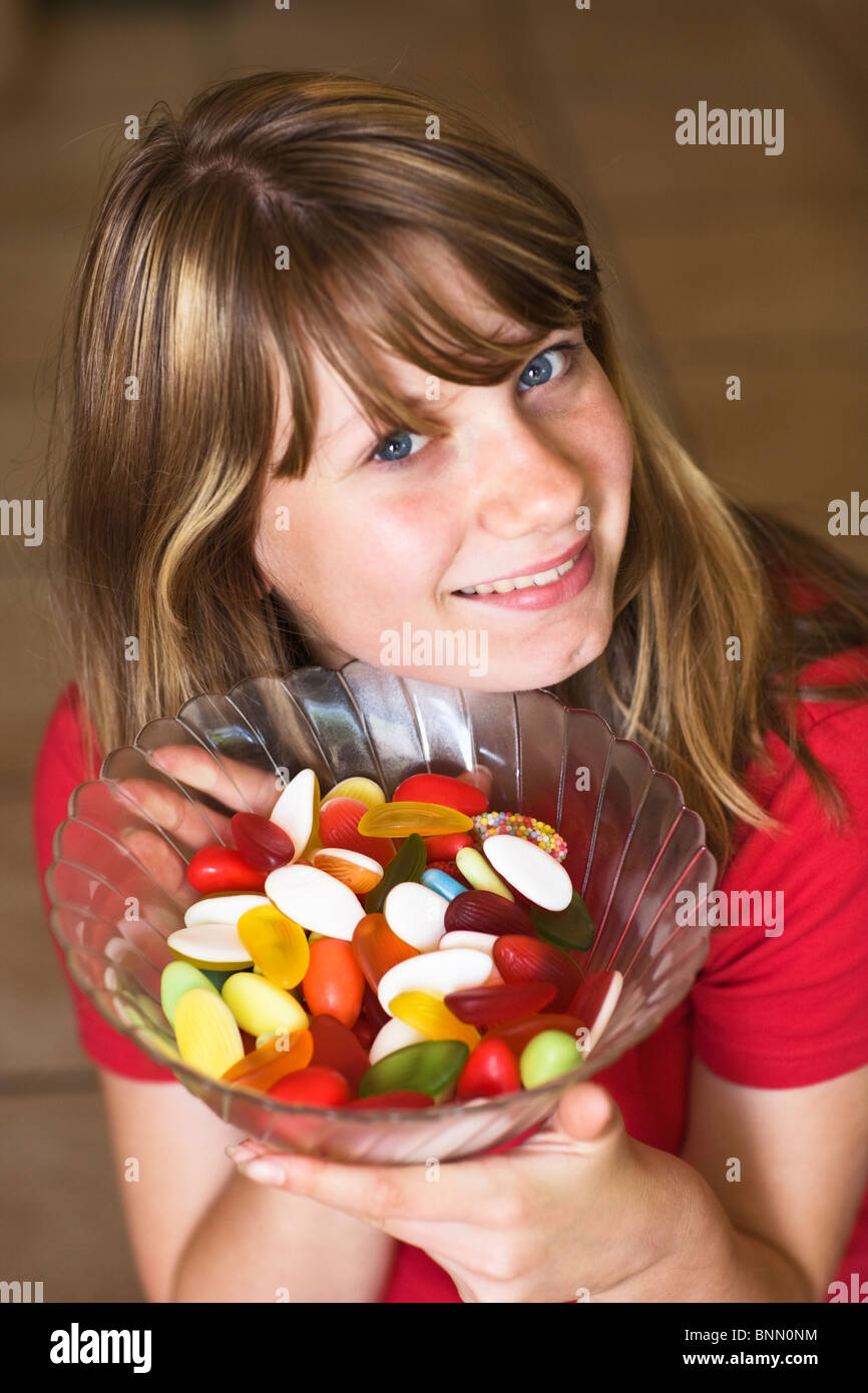 Girl with bowl of Candy Stock Photo - Alamy