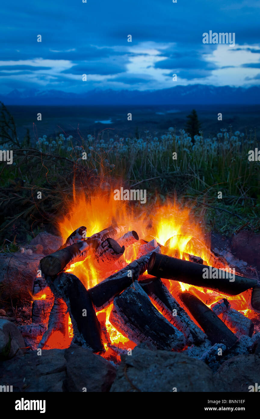 Camp fire with a view of the Chugach Mountain in the distance, Wrangell ...