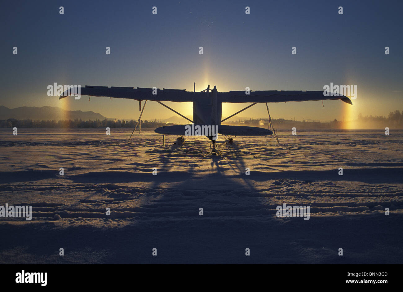 Silhouette of Ski Plane & Sundogs Lake Hood Alaska Stock Photo - Alamy