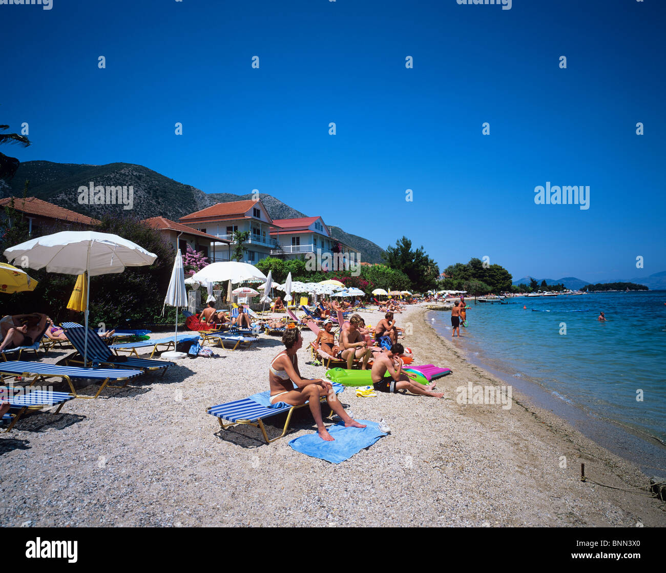 Beach scene at the picturesque resort of Nidri on the Greek island of ...