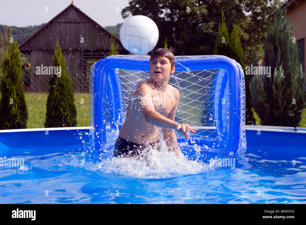 Teenager throwing water polo ball in the pool Stock Photo - Alamy