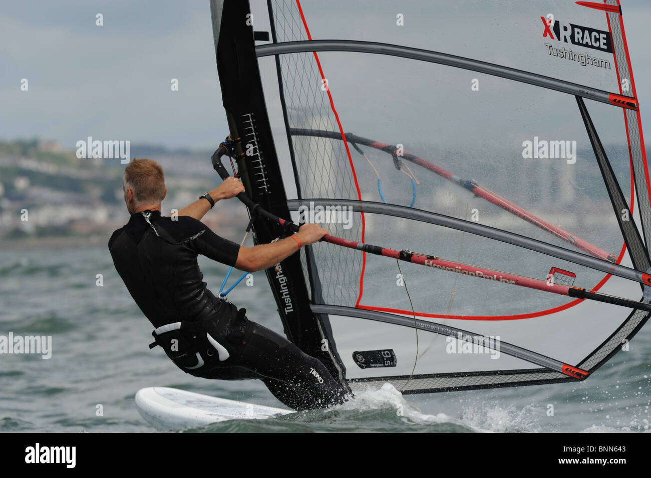 Course board windsurfer racing at full tilt Stock Photo - Alamy