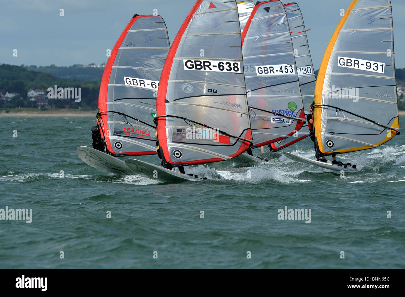 a group of windsurfers race towards the windward mark Stock Photo - Alamy