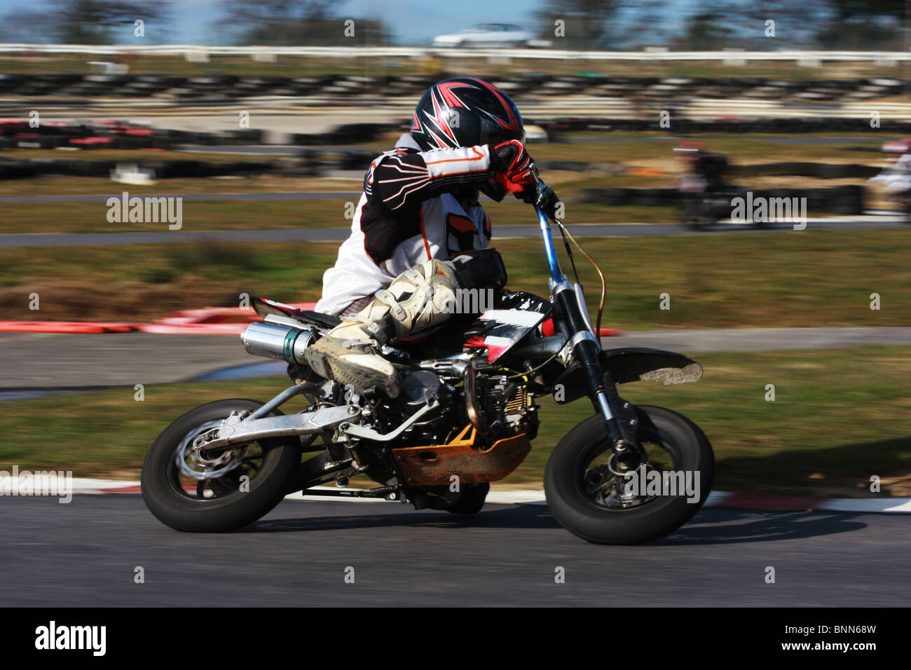 A speeding motor cycle on a race track Stock Photo - Alamy