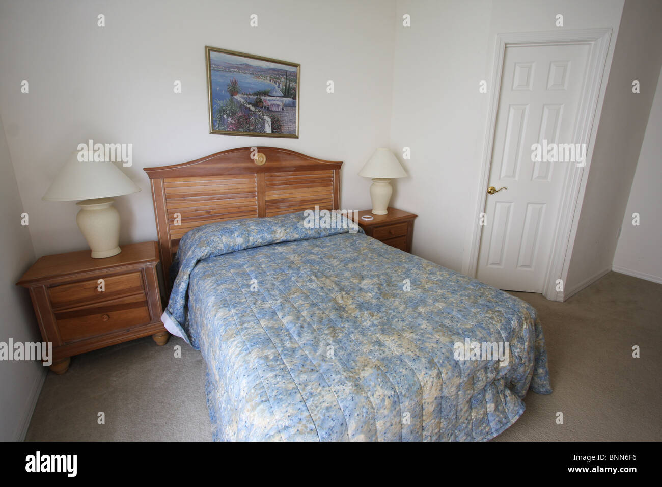 A bedroom with a double bed Stock Photo - Alamy