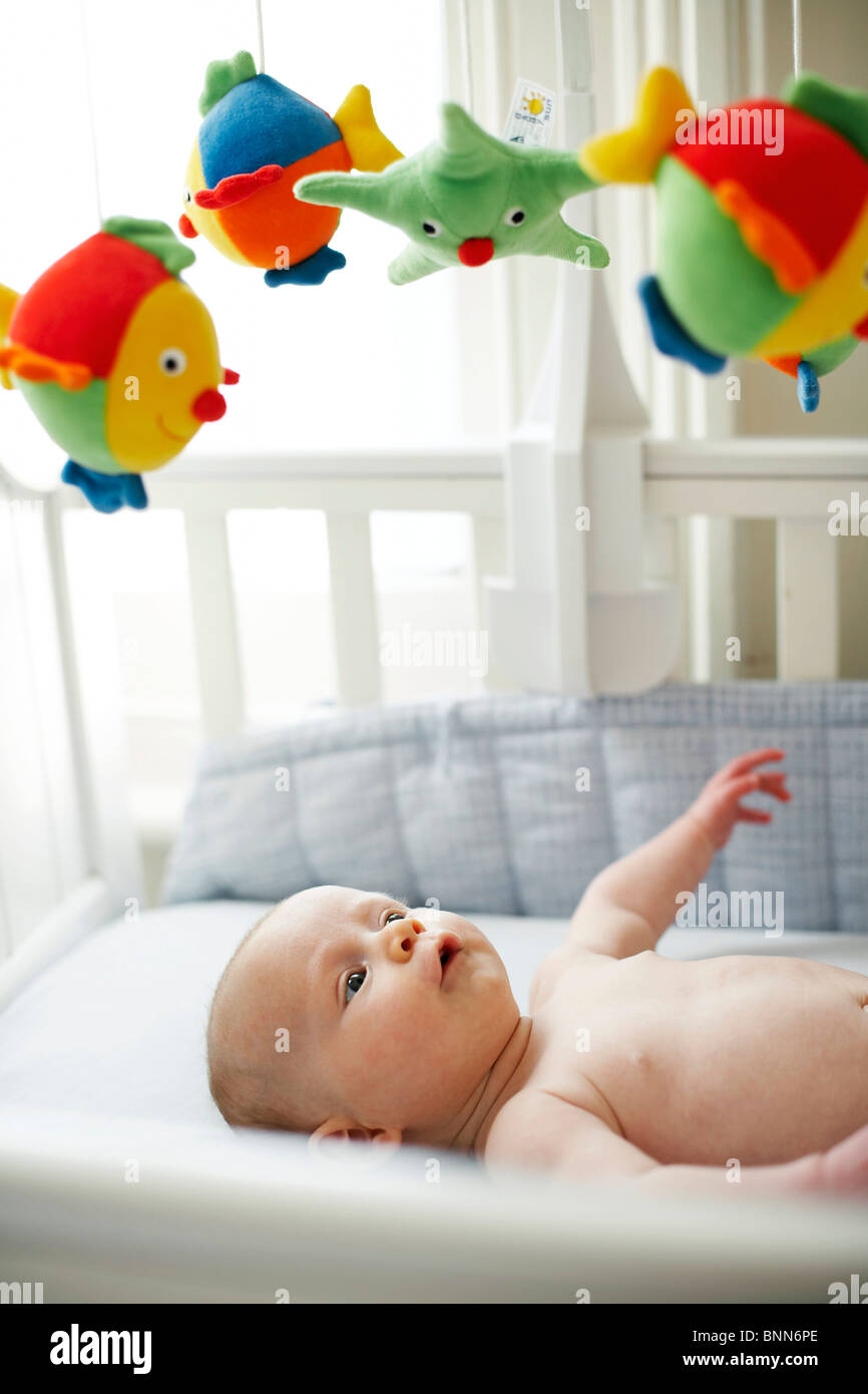 Baby boy in his cot Stock Photo - Alamy