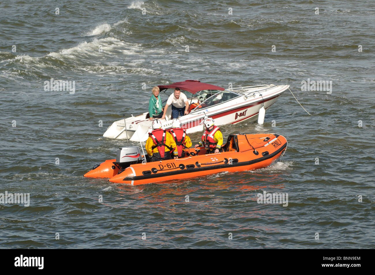 RNLI inshore rescue boat checking on couple on powerboat off Burry Port ...