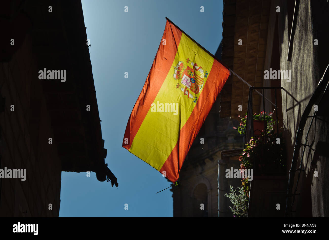 Spanish flag flying from a house in Adahuesca, Spain Stock Photo - Alamy