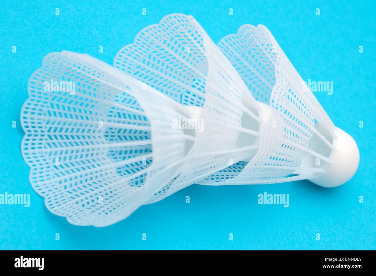 Three white plastic shuttlecocks Stock Photo - Alamy