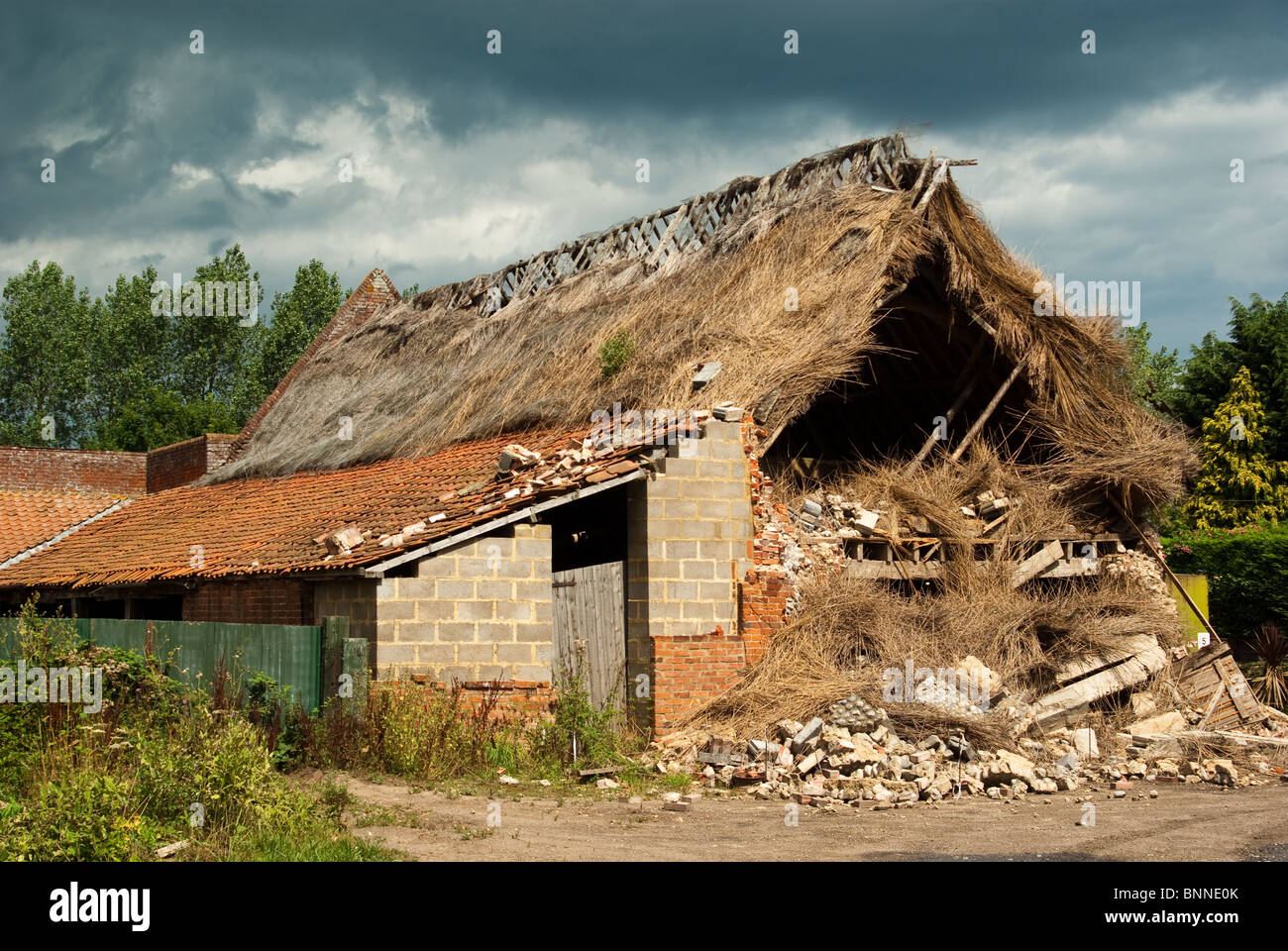 storm damaged thatch on farm barn Stock Photo - Alamy