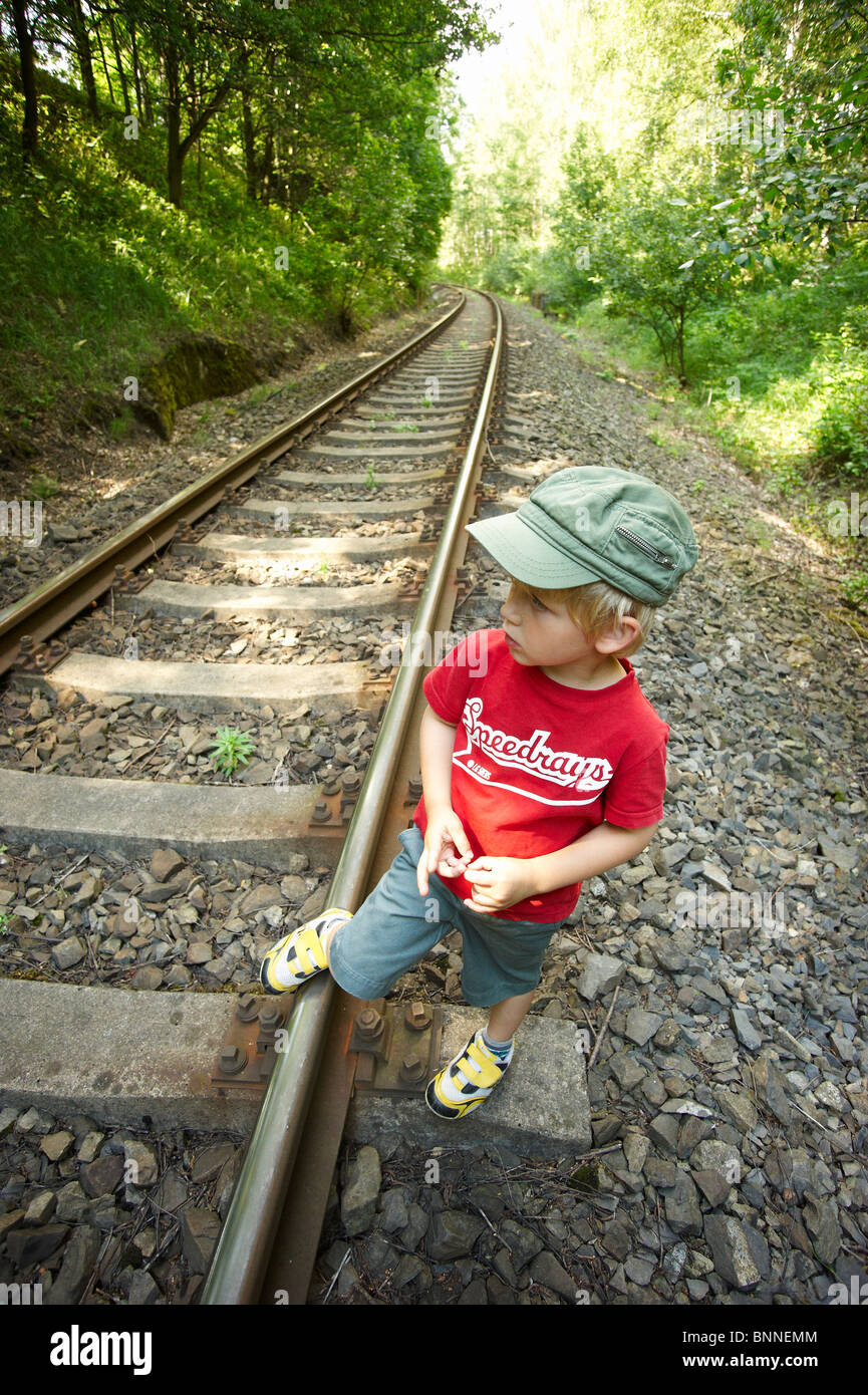 Child Boy Standing on Railroad Tracks Stock Photo - Alamy