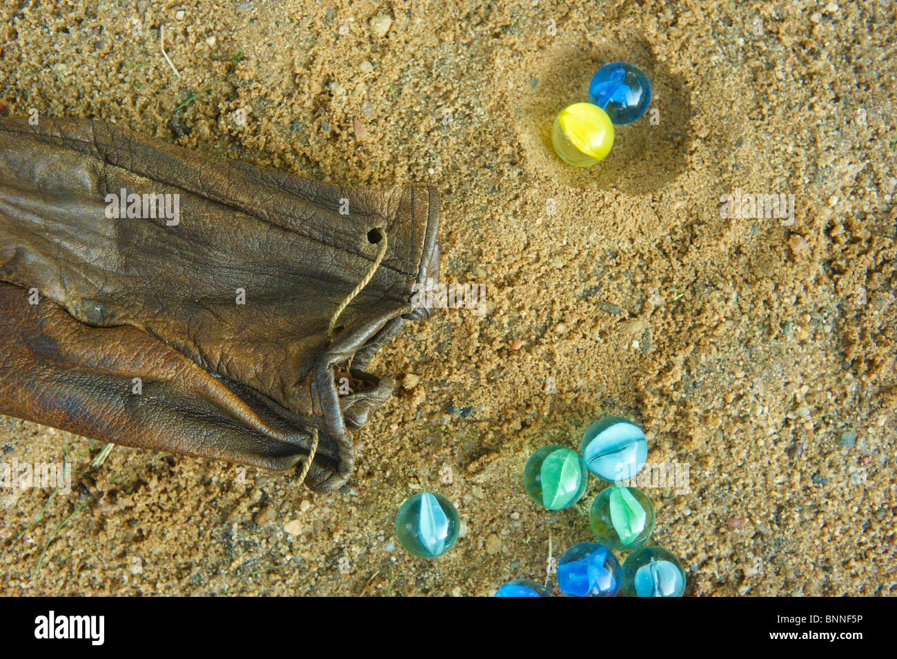Playing with marbles on sand Stock Photo - Alamy
