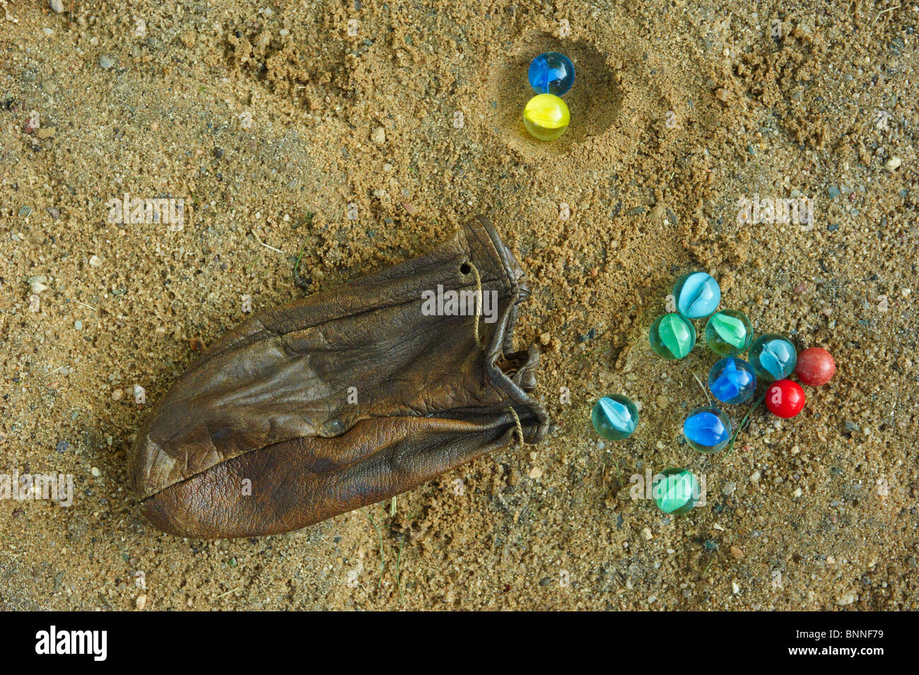 Playing with marbles on sand Stock Photo - Alamy