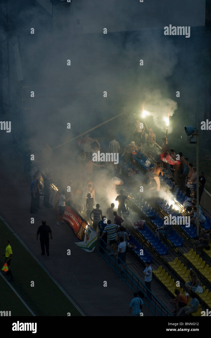 Tribune with football fans lighting the fires Stock Photo - Alamy