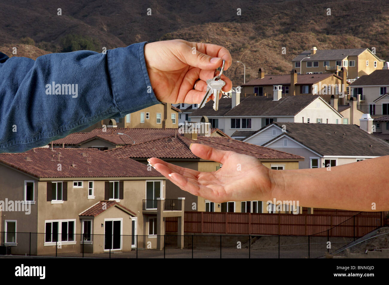 Man's Hand Handing Over the Keys of a New Home to a Woman's Hand with ...
