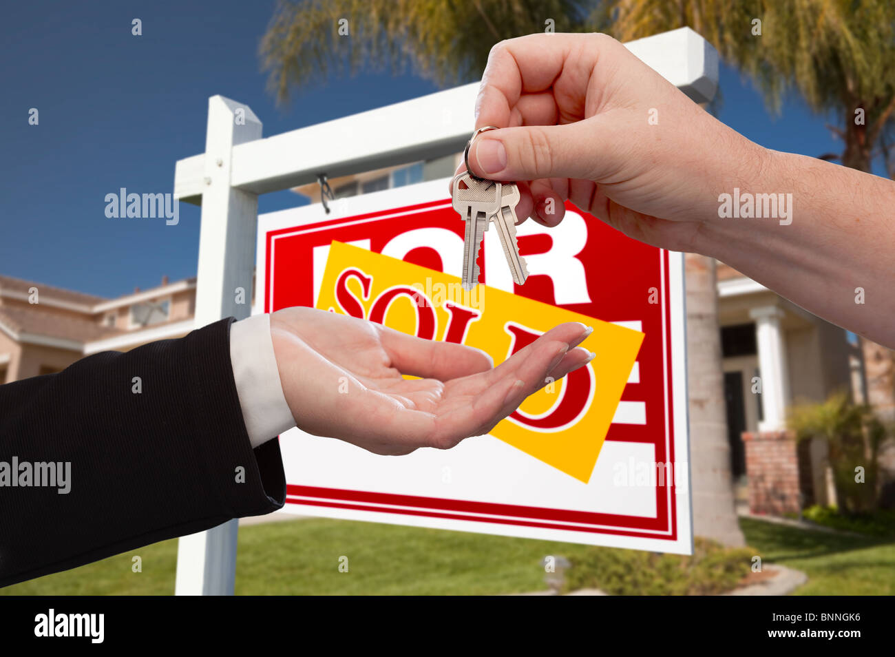 Man's Hand Handing Over the Keys of a New Home to a Woman's Hand with ...