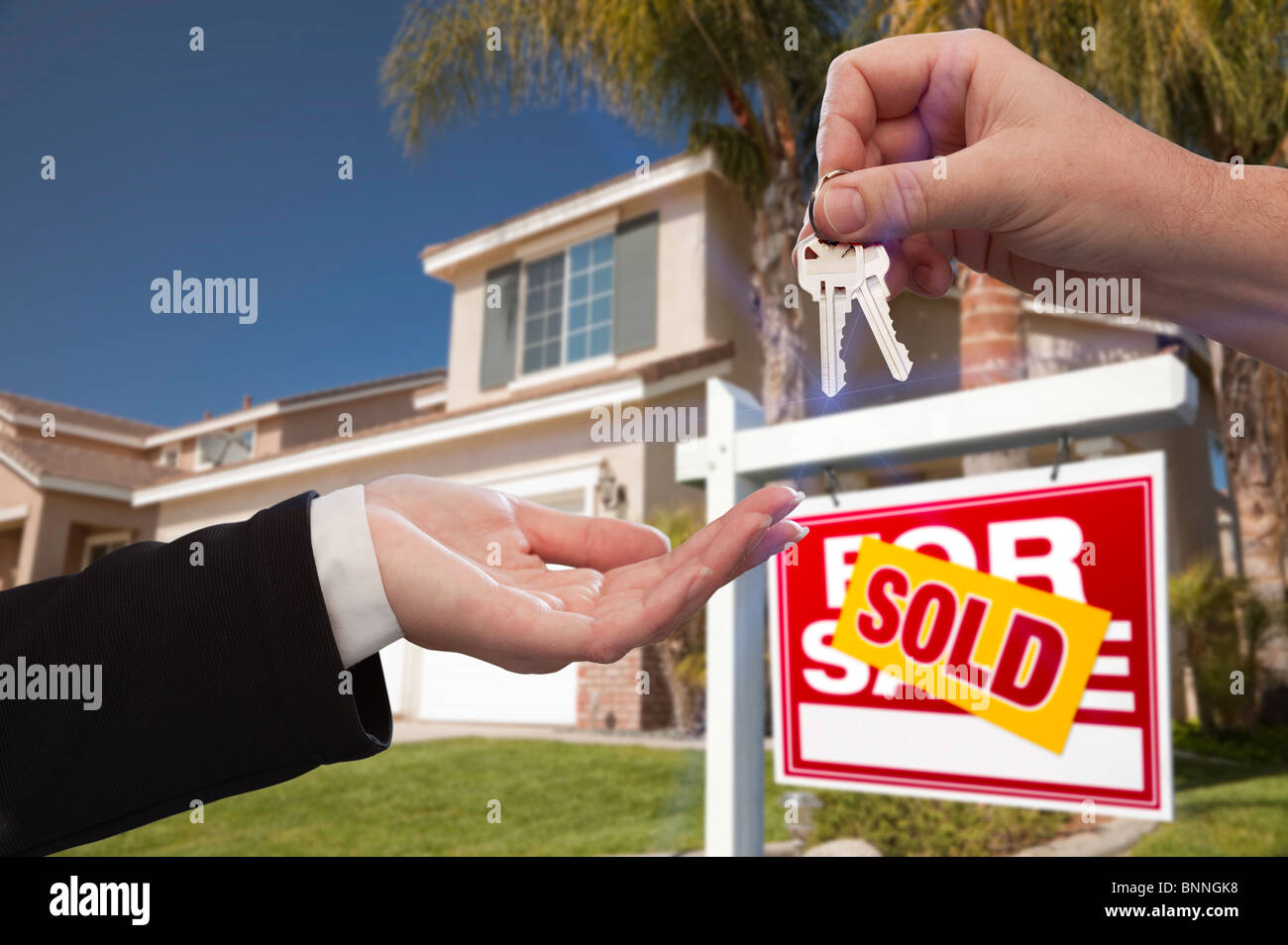 Man's Hand Handing Over the Keys of a New Home to a Woman's Hand with ...