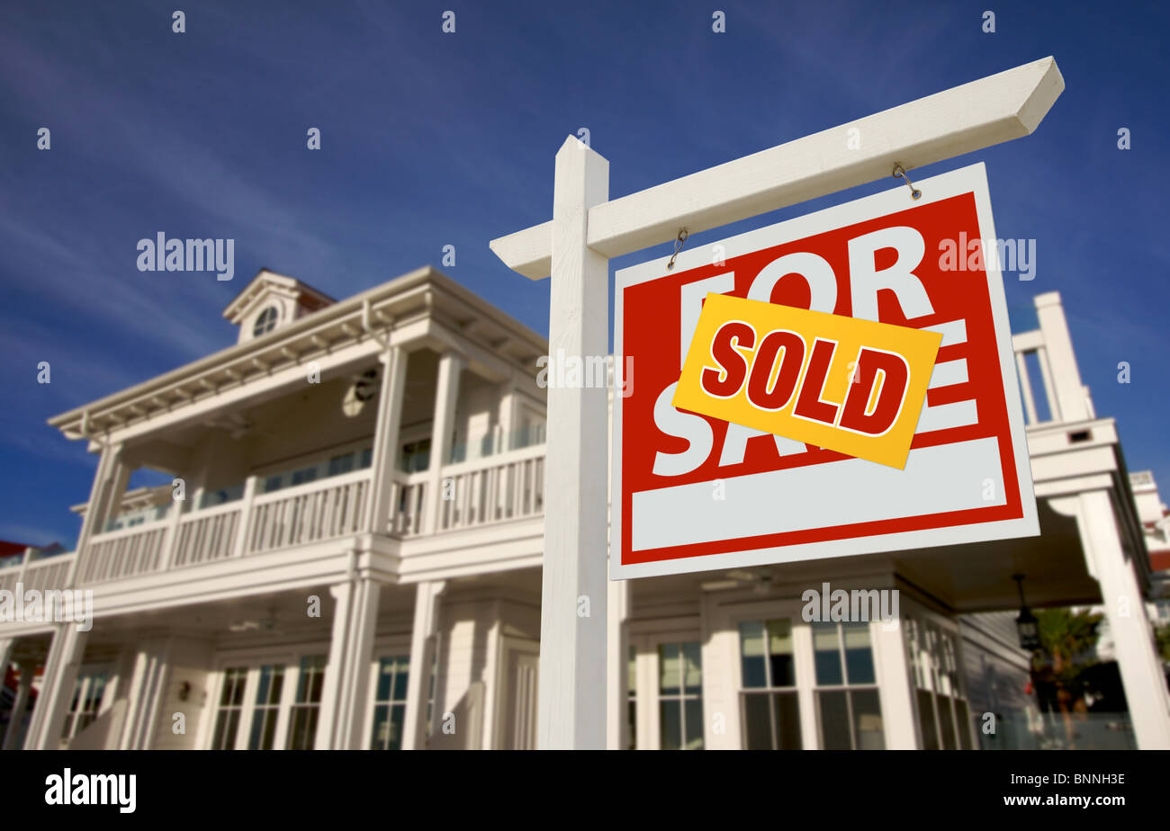 Sold Home For Sale Sign in Front of Beautiful New House Stock Photo - Alamy