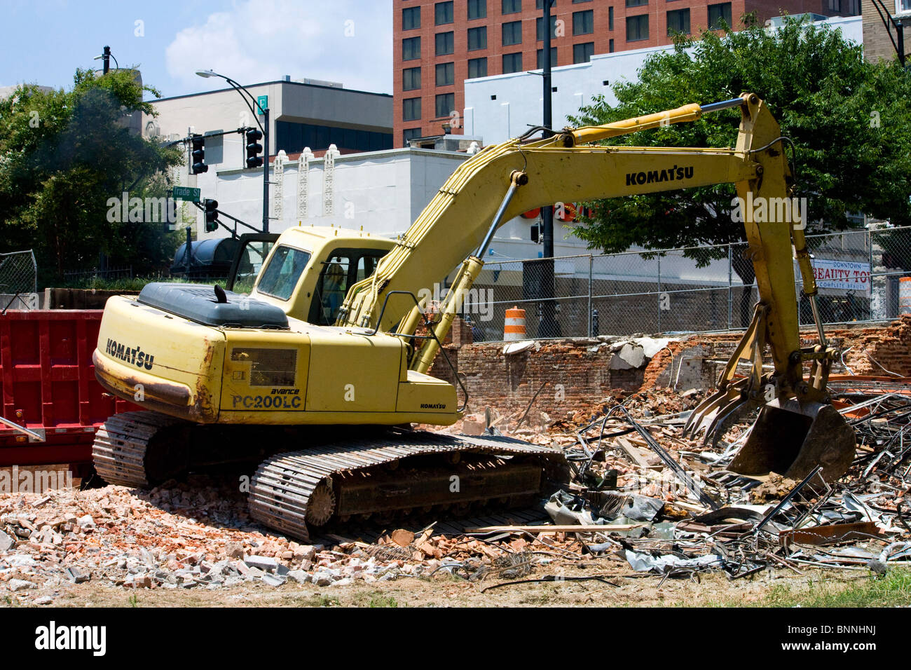 Komatsu Excavator cleaning up demolished building Stock Photo - Alamy