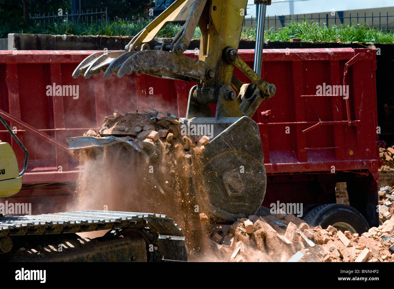 Excavator bucket full of demolition debris Stock Photo - Alamy