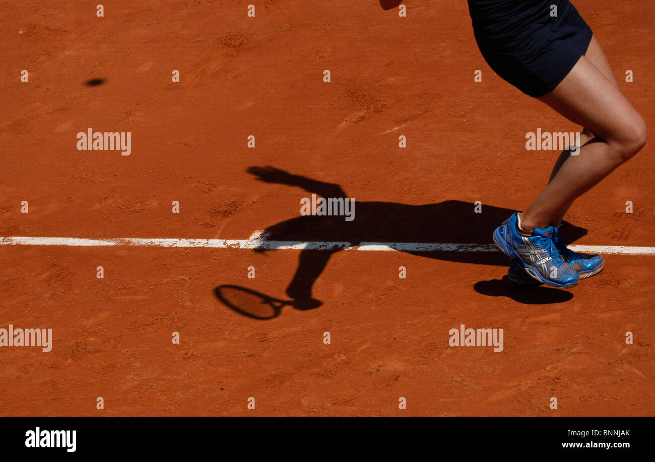 Shadow of a female tennis player on red clay court of Roland Garros ...