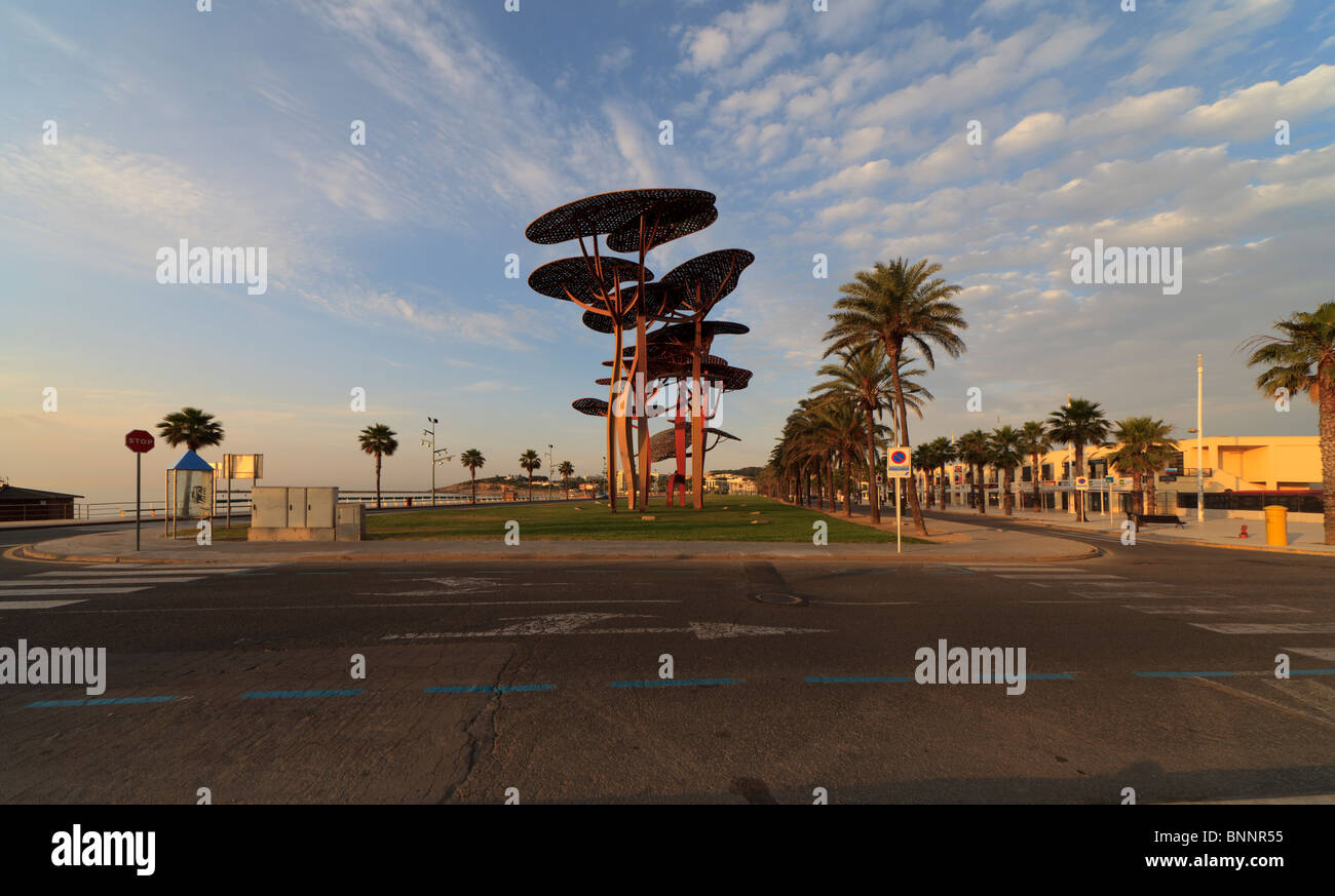 Dawn on the promenade of La Pineda, sculpture, palm trees, Spain Stock ...