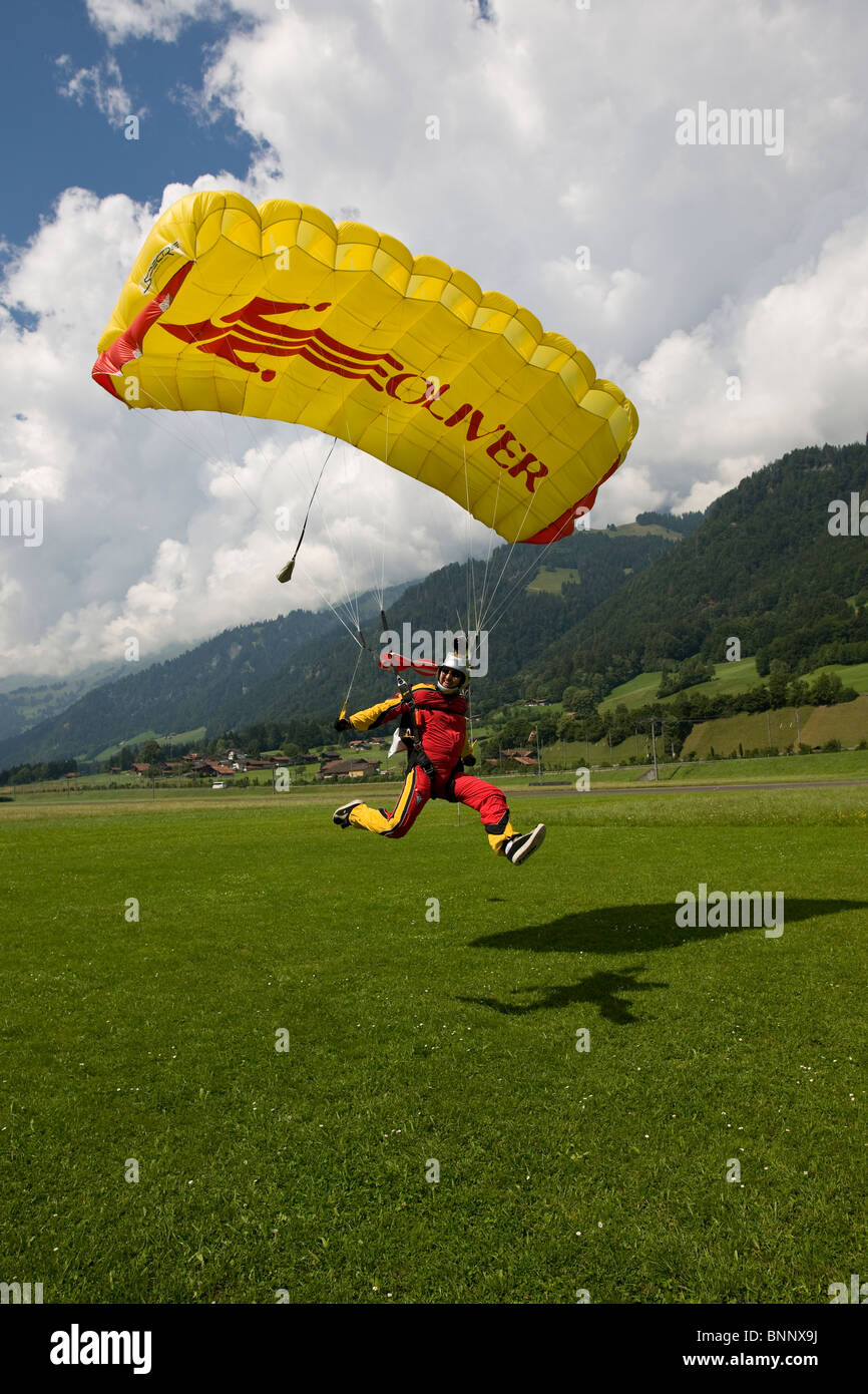 Skydiver camera flayer is landing his parachute safely. He is touch ...