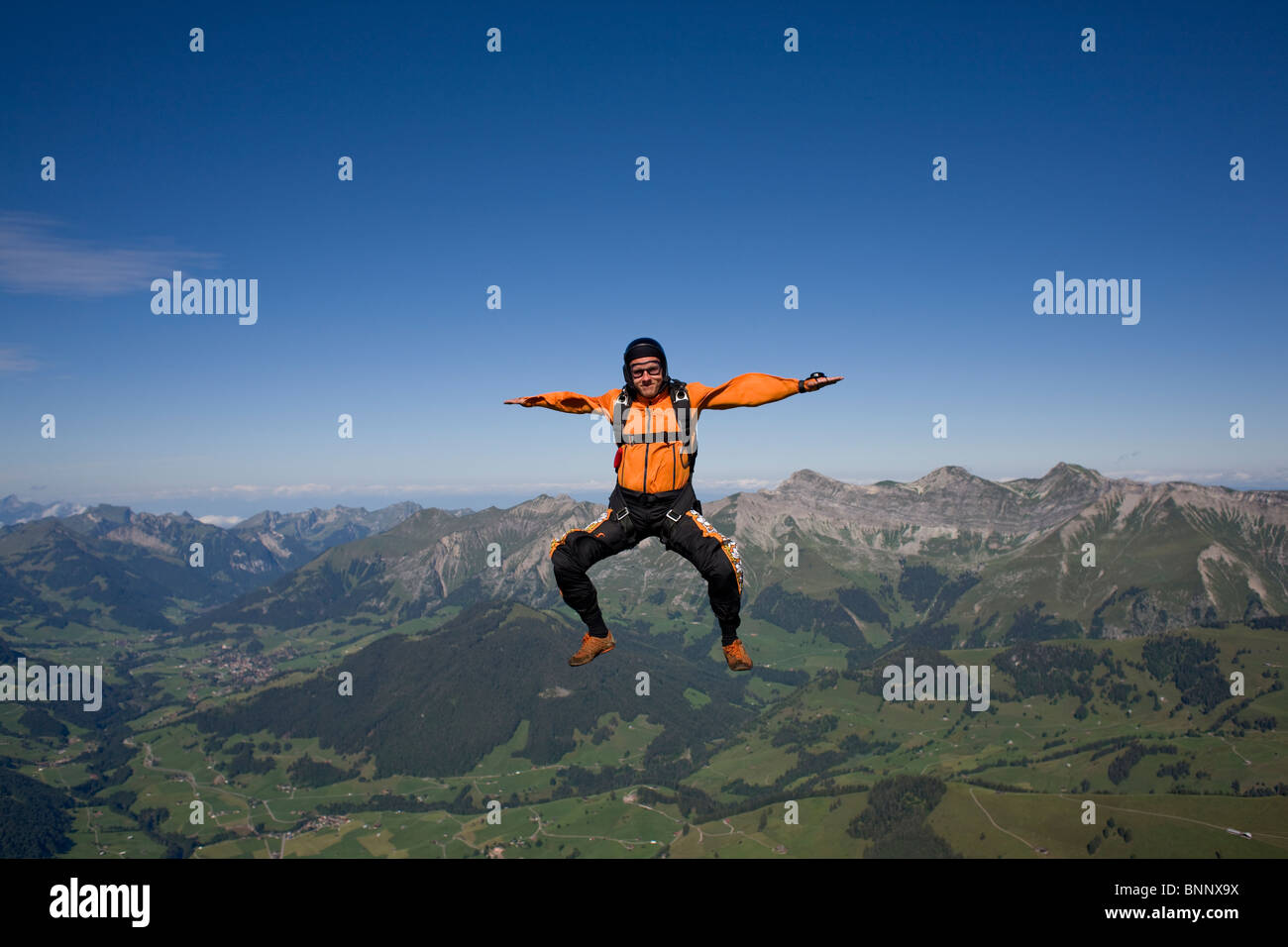 Skydiver is flying headup in the sky within with a sit fly position ...