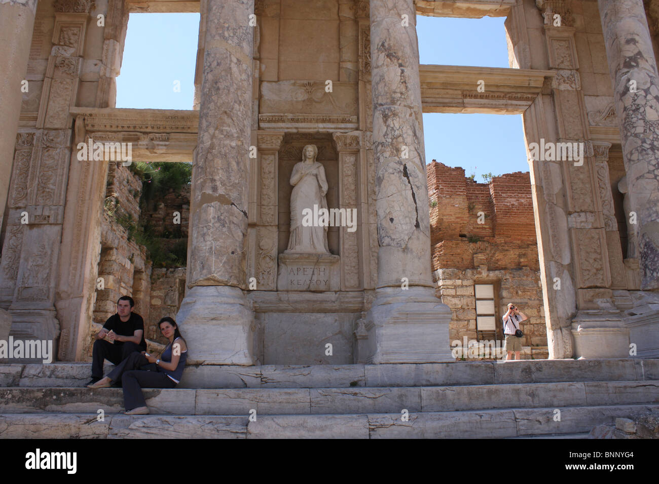 Tourists by the ruins of the Roman library, Celsus, In Ephesus in ...