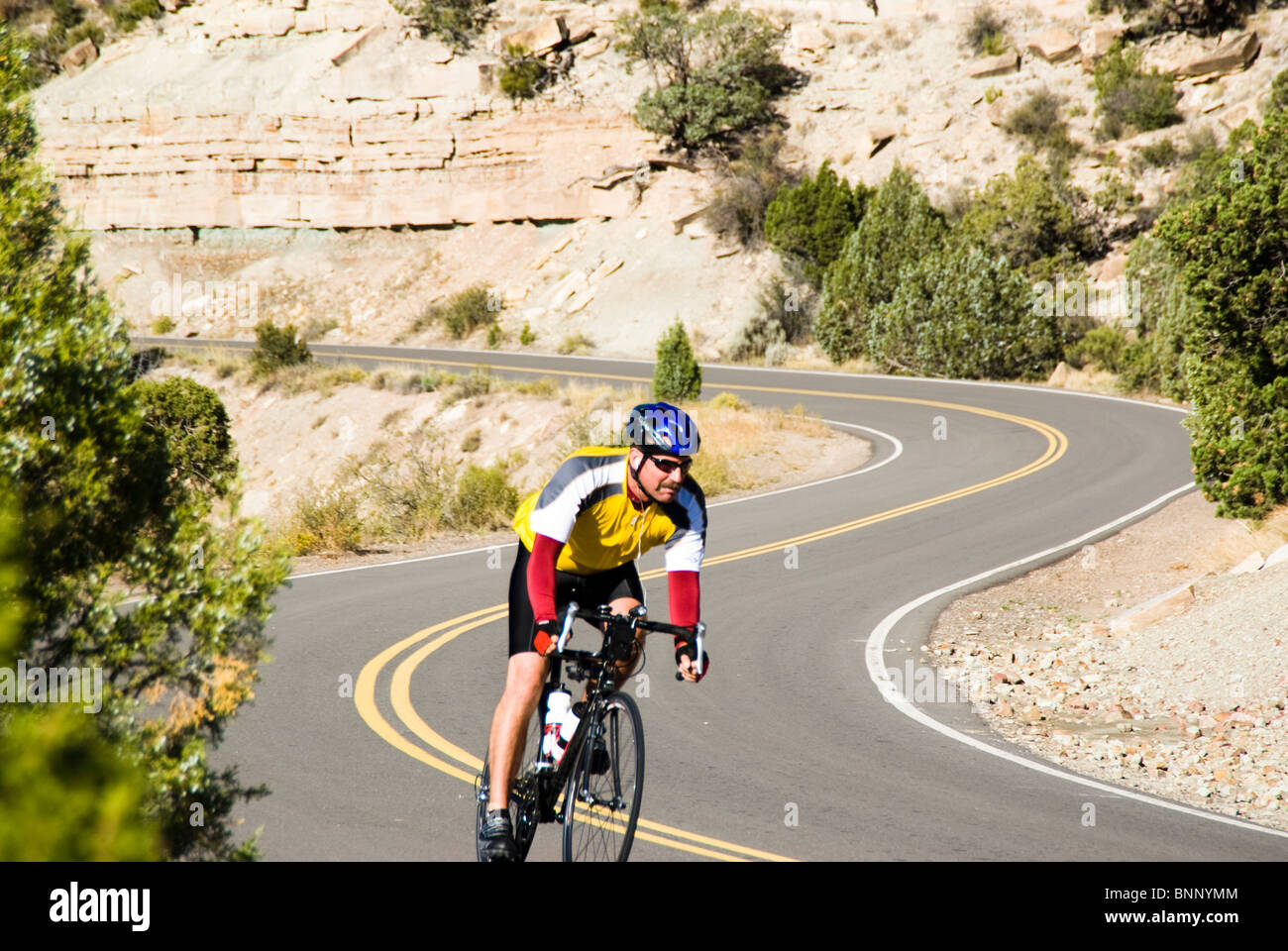 A biker rides the curves on the scenic Rim Rock Drive in Colorado ...