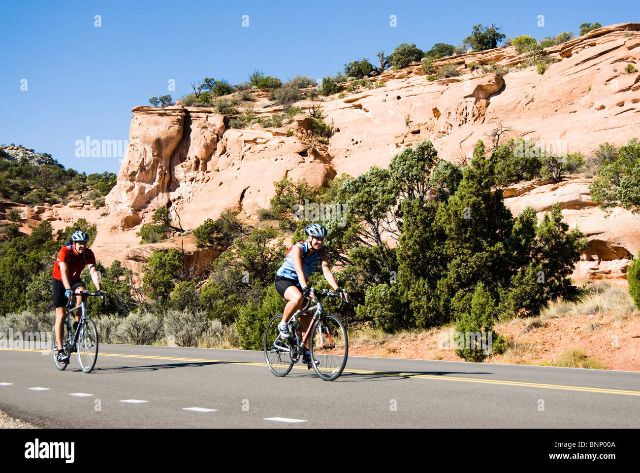 Two bikers enjoy a ride on the scenic Rim Rock Drive in Colorado ...