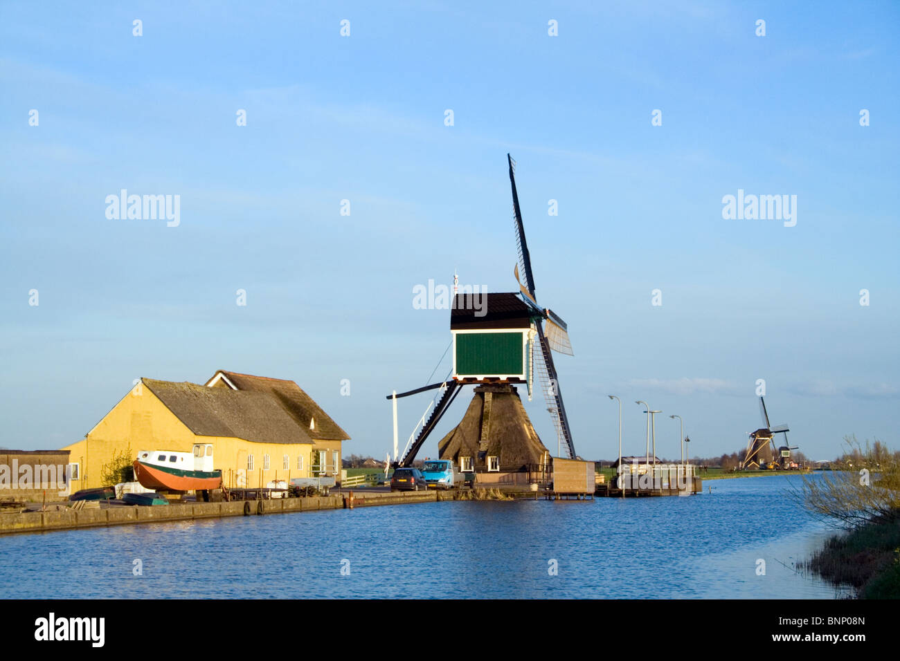Windmill next to a river in a polder in Holland Stock Photo - Alamy