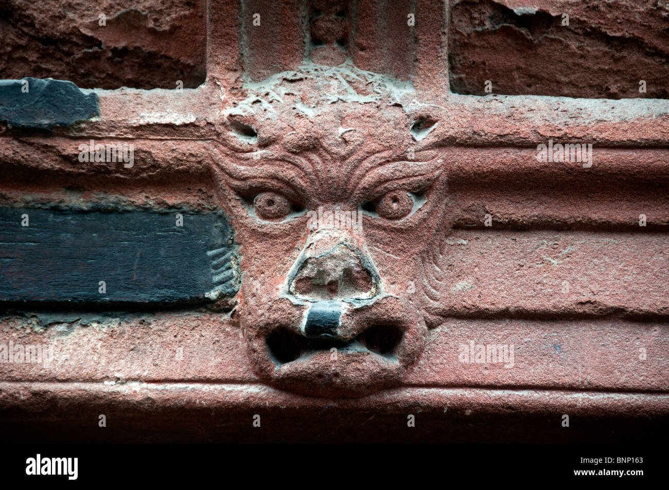A stone carved gargoyle head on a house in Cumbria Stock Photo - Alamy