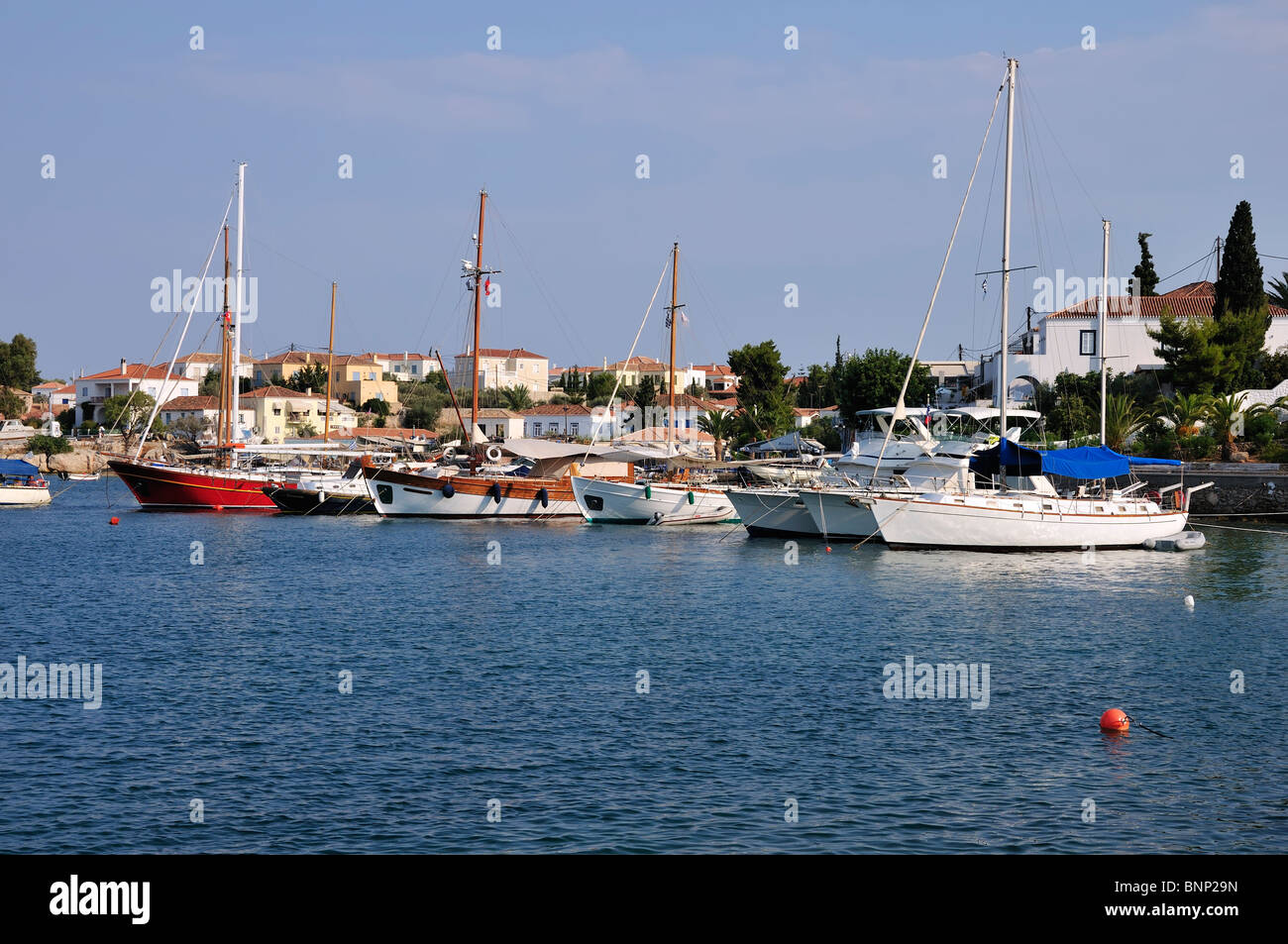 Sailing yachts and motor yachts at the old port, Spetses town, Spetses ...