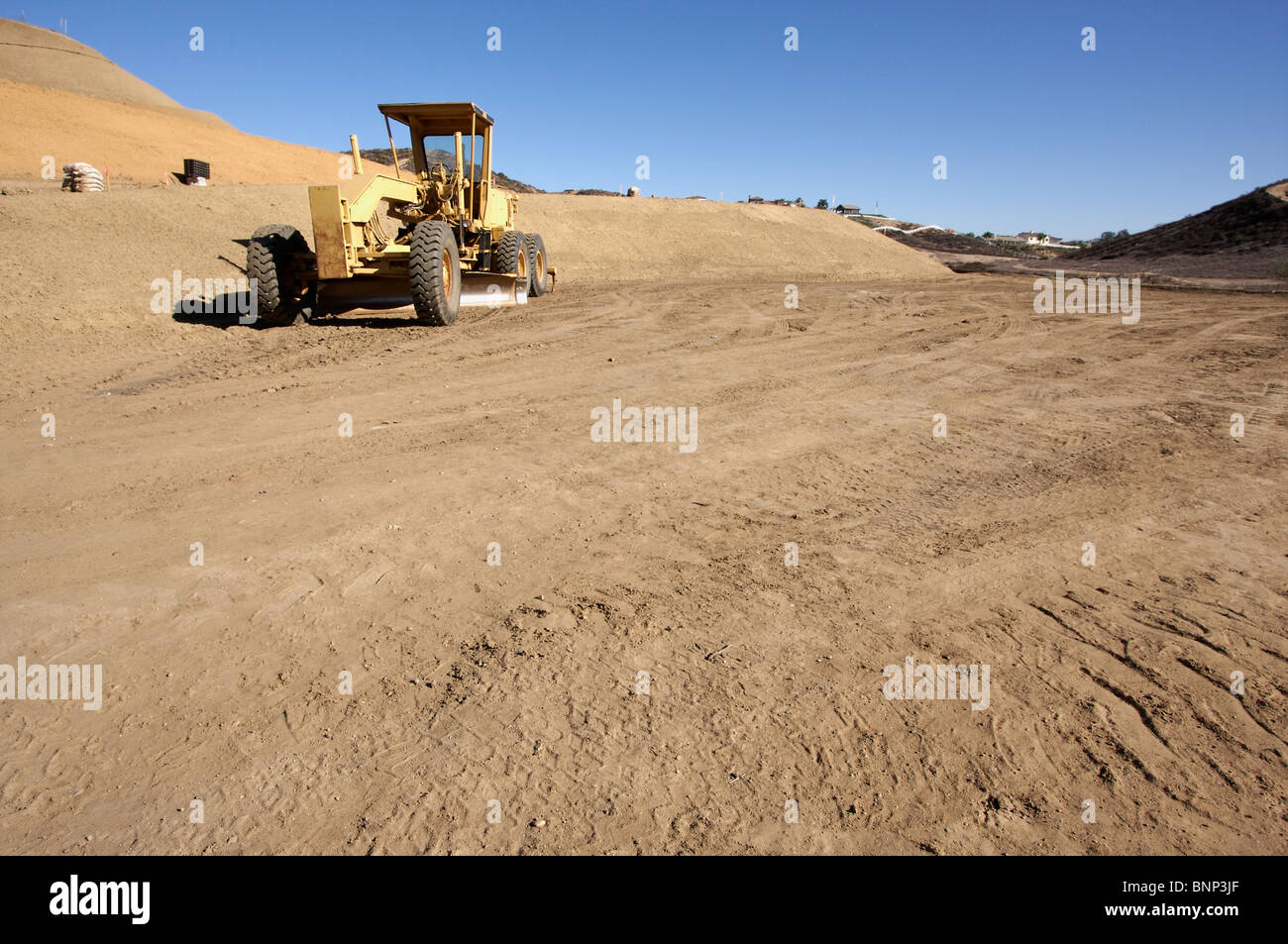 Tractor at a Construction Site and dirt lot Stock Photo - Alamy