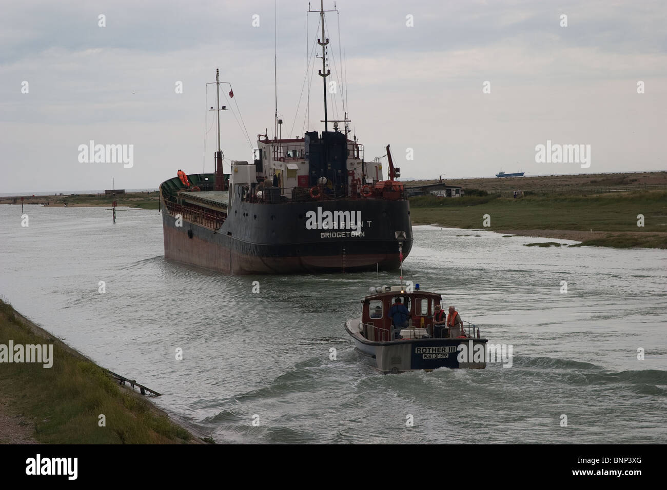 small cargo boat tanker river channel cloudy sky Stock Photo - Alamy