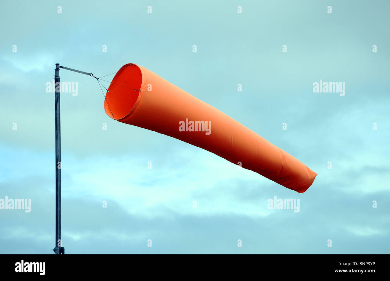 a wind sock in a medium/strong south westerly wind Stock Photo - Alamy
