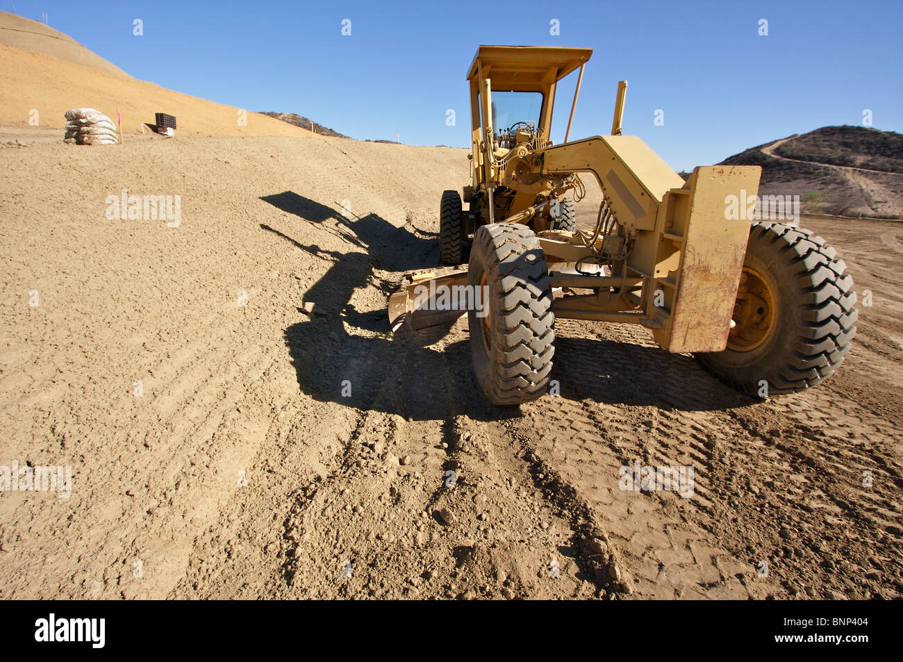 Tractor at a Construction Site and dirt lot Stock Photo - Alamy