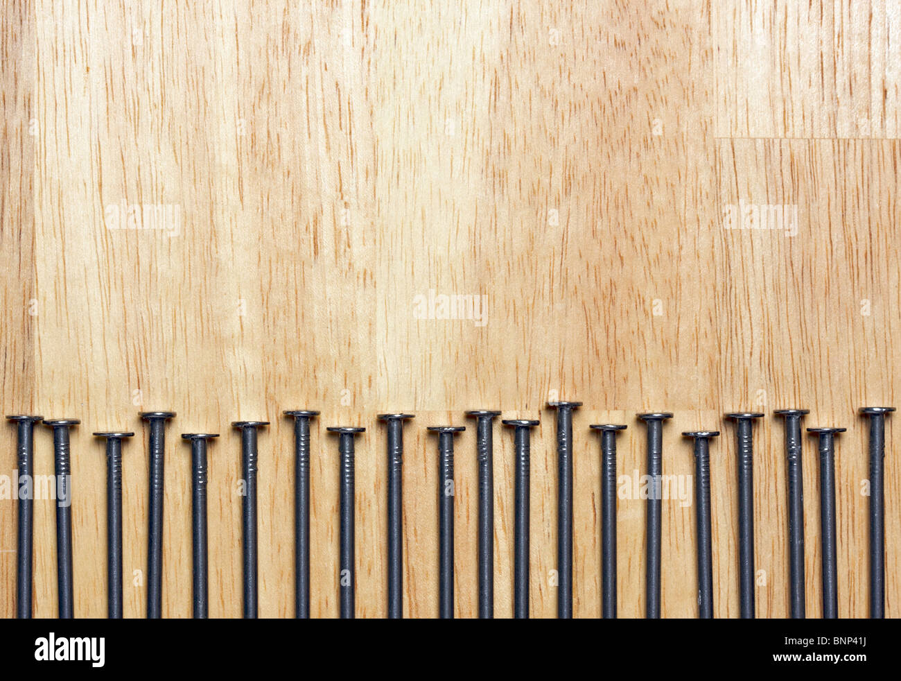 Macro of Nails on a Wood Background Stock Photo - Alamy
