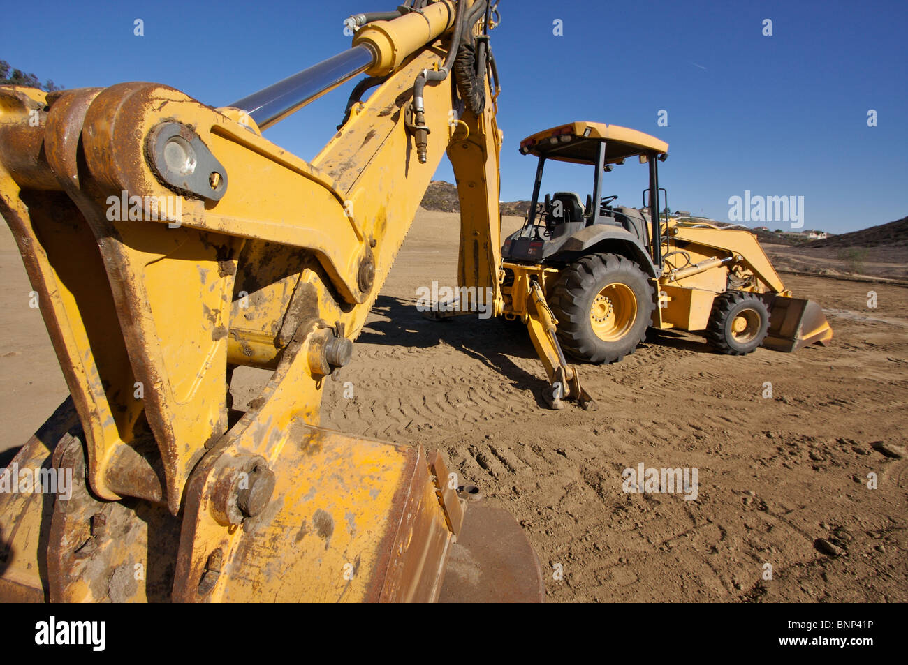 Tractor at a Construction Site and dirt lot Stock Photo - Alamy