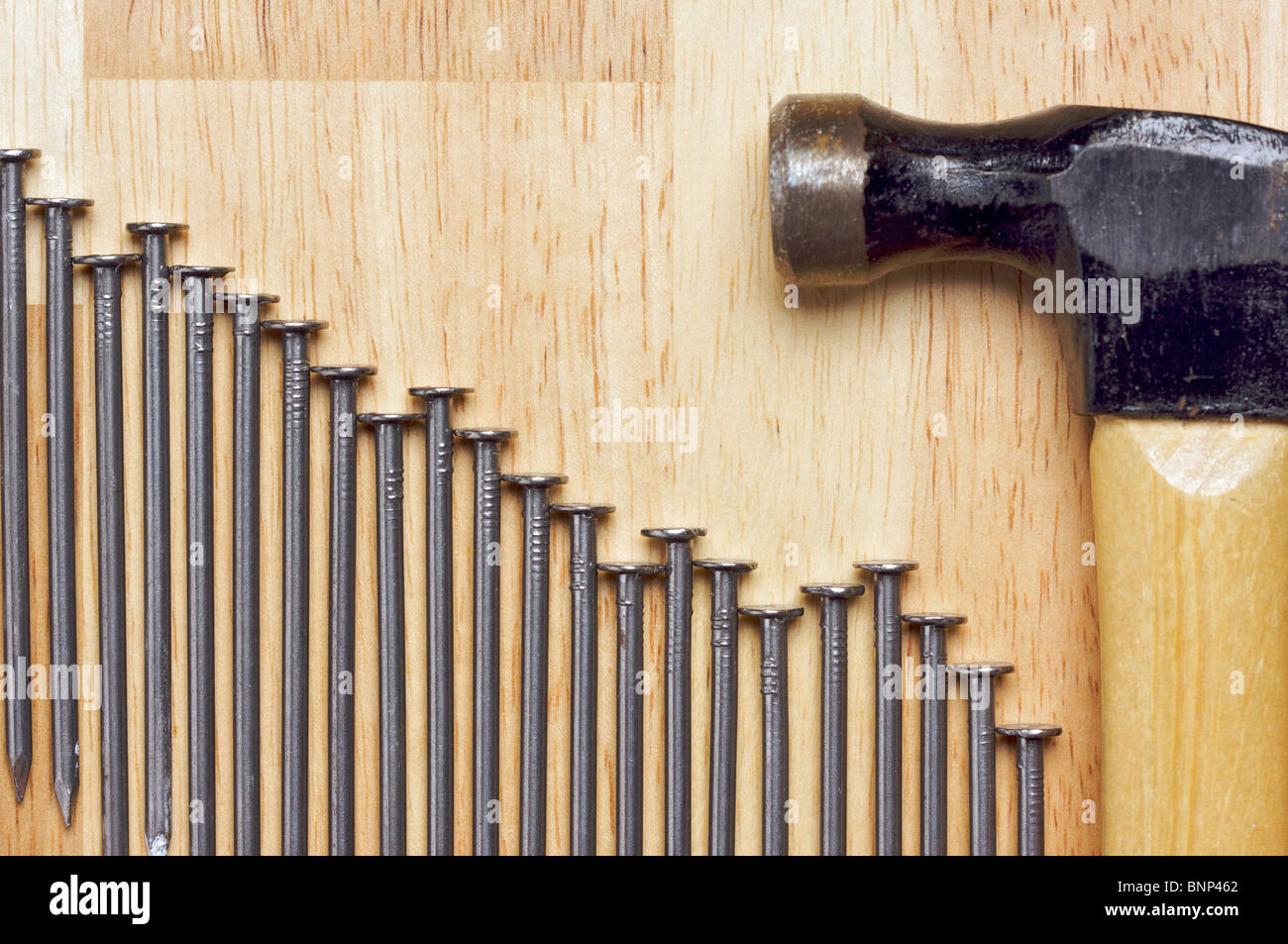 Hammer and Declining Graph of Nails Abstract on Wood Background Stock ...