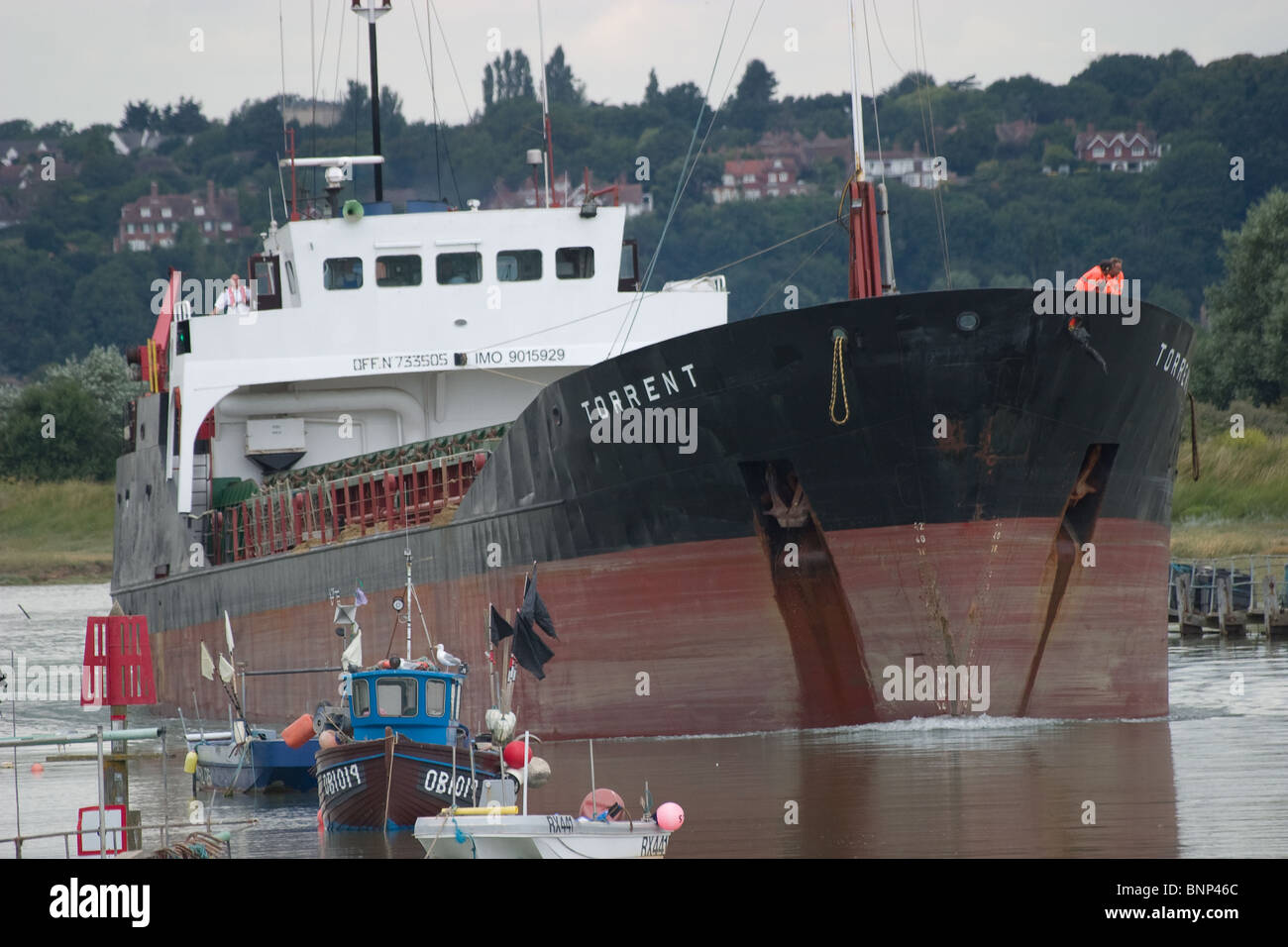 small cargo boat tanker river channel cloudy sky Stock Photo - Alamy