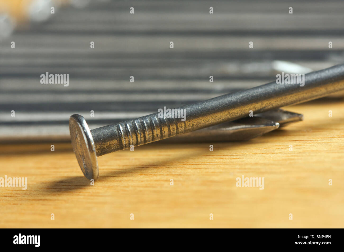Macro of Nails on a Wood Background Stock Photo - Alamy